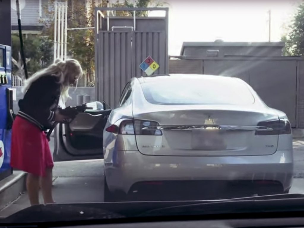 Video of Woman Driving Tesla Gas Station screenshot post - Source